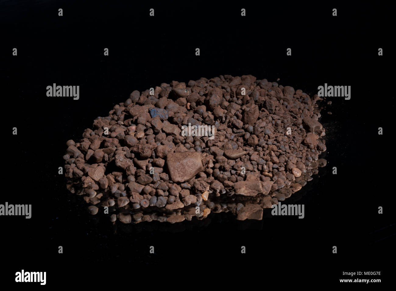 Ore from a diamond mine. isolated on black background with reflexion ...