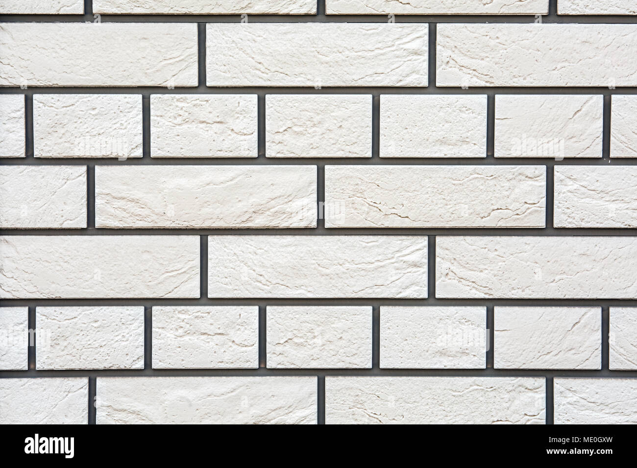 Tiles of house facade, white brick wall background Stock Photo - Alamy