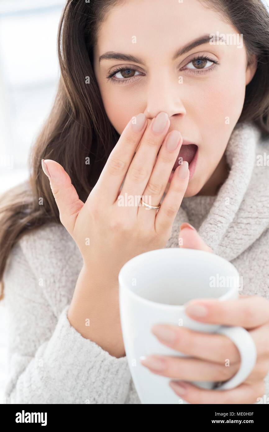 Yawning woman covering mouth hand hi-res stock photography and images ...