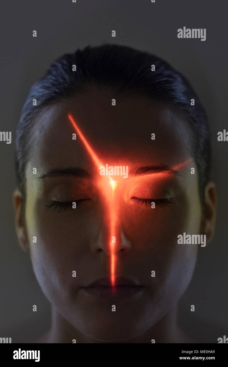 Woman with red light on face Stock Photo - Alamy