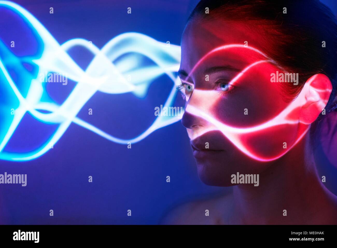 Woman with lights on face Stock Photo - Alamy