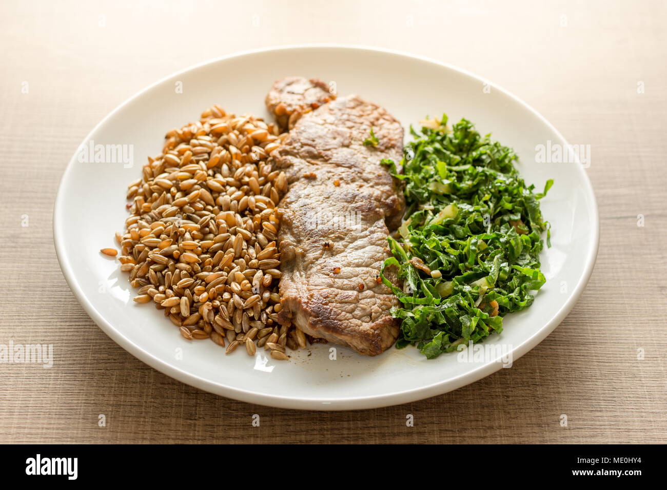 Meal with rye, steak and cabbage on a white plate. Healthy eating Stock ...