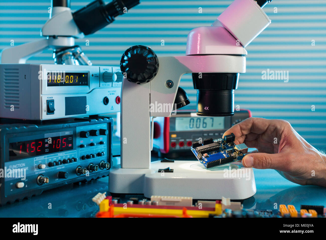Examining circuit board with microscope Stock Photo - Alamy