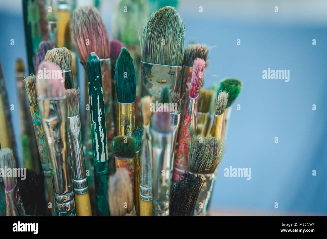 Set of artistic multicolor brushes on a blue background. Soft focus ...