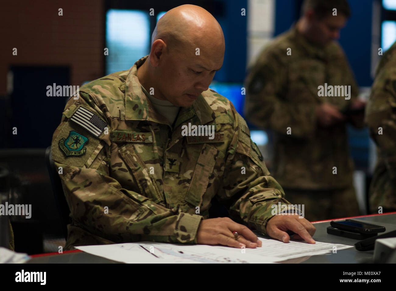 Col. Jimmy Canlas, 437th Airlift Wing commander, reviews a handout ...
