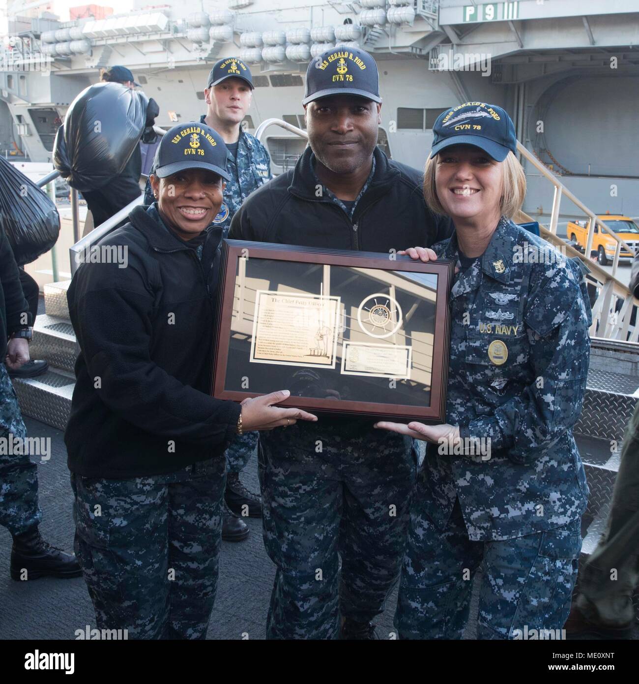NORFOLK, Va. (Dec. 18, 2017) -- Chief Yeoman Berwyn Tinnion receives a ...