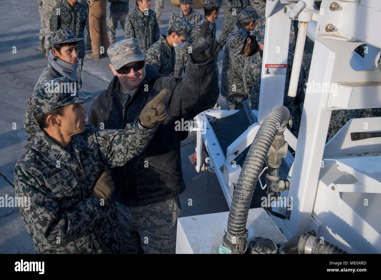 A U.S. Air Force Airman with the 374th Civil Engineer Squadron points ...