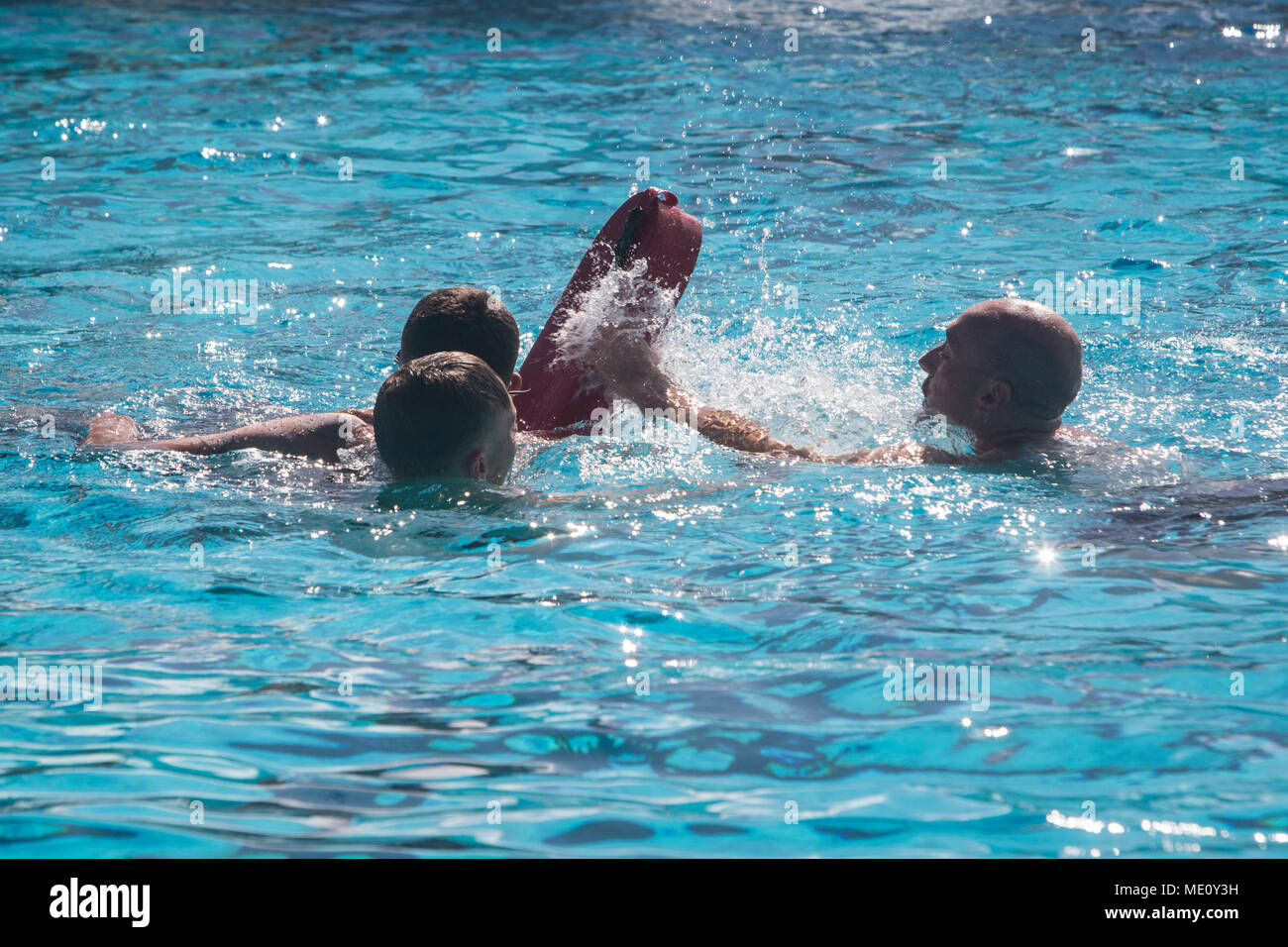 A Marine Corps Instructor of Water Survival (MCIWS) reaches for a ...
