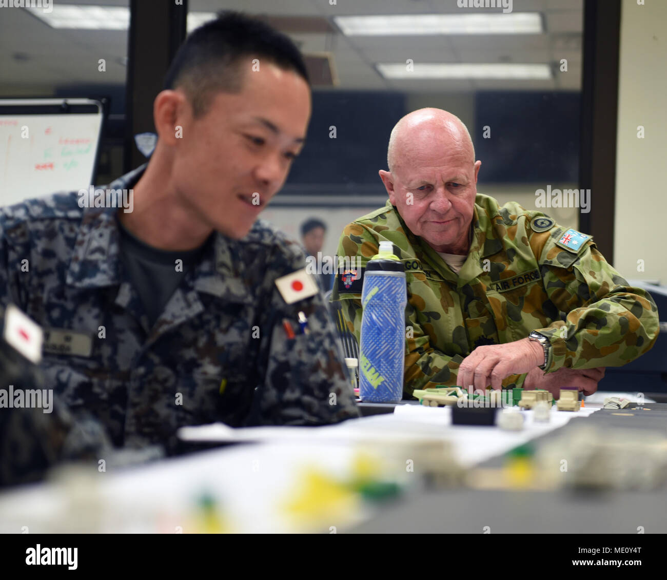 Service members set model trucks on a map during a multinational Silver ...