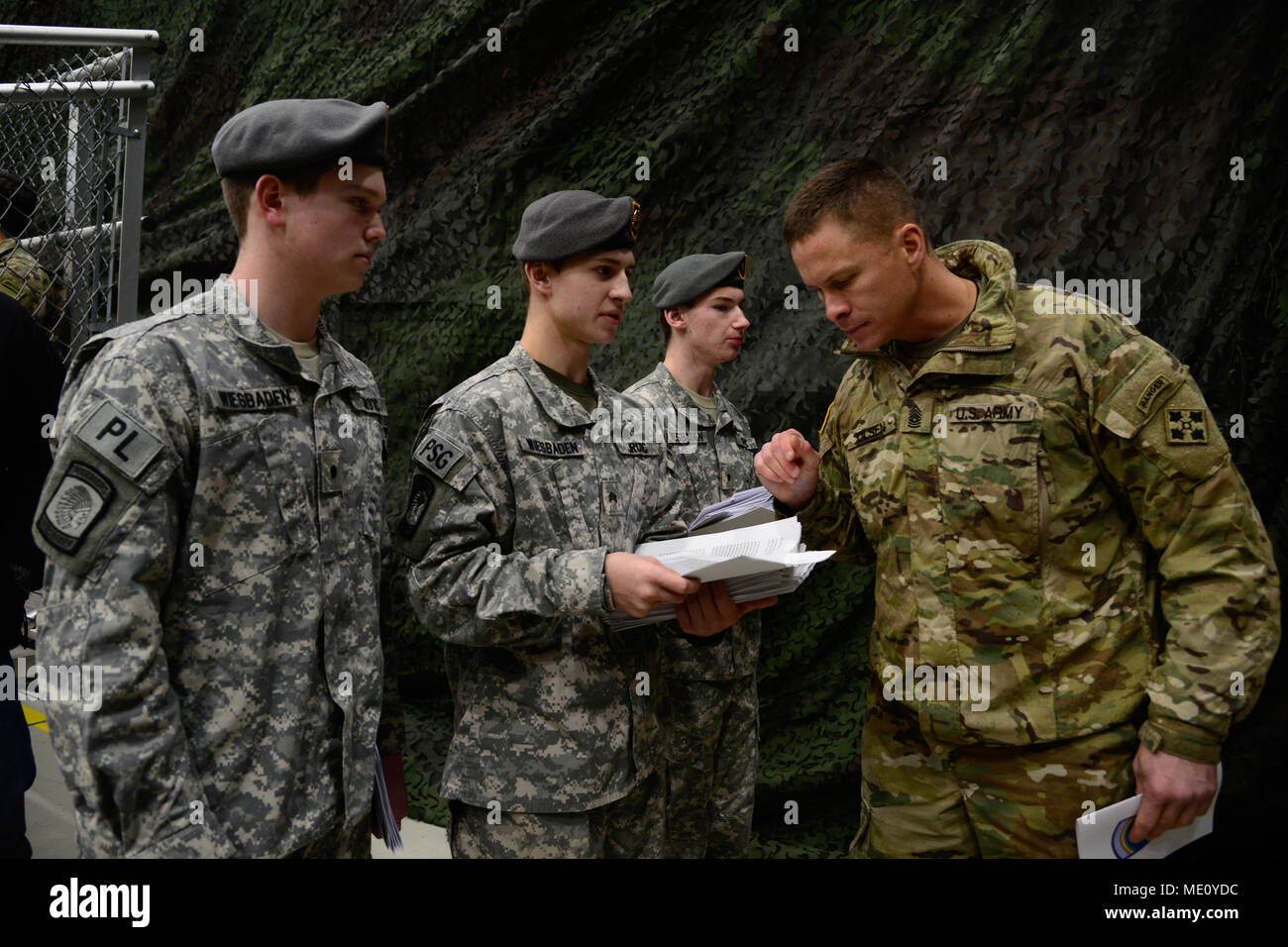 U.S. Army Command Sgt. Maj. Eric Olsen, right, assigned to 4th Infantry ...