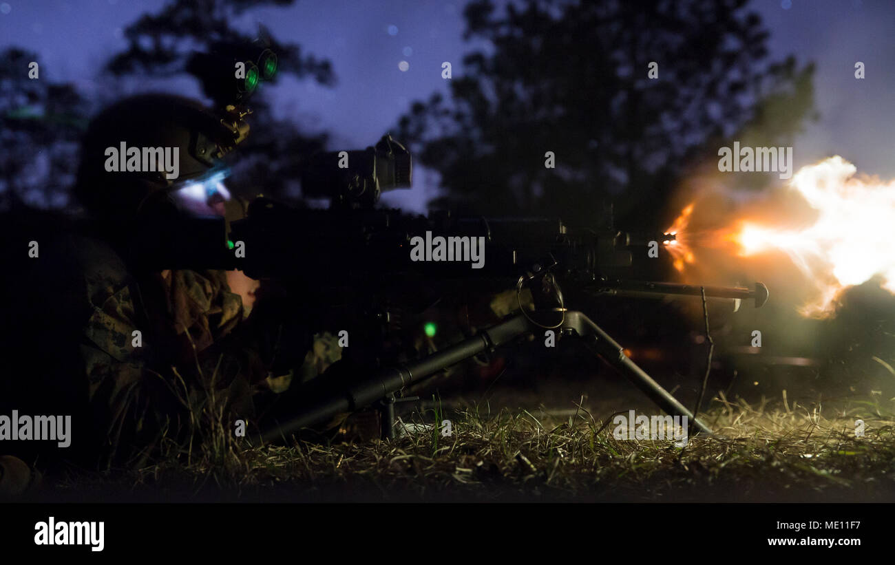 A Marine with 2nd Reconnaissance Battalion fires an M249 light machine ...
