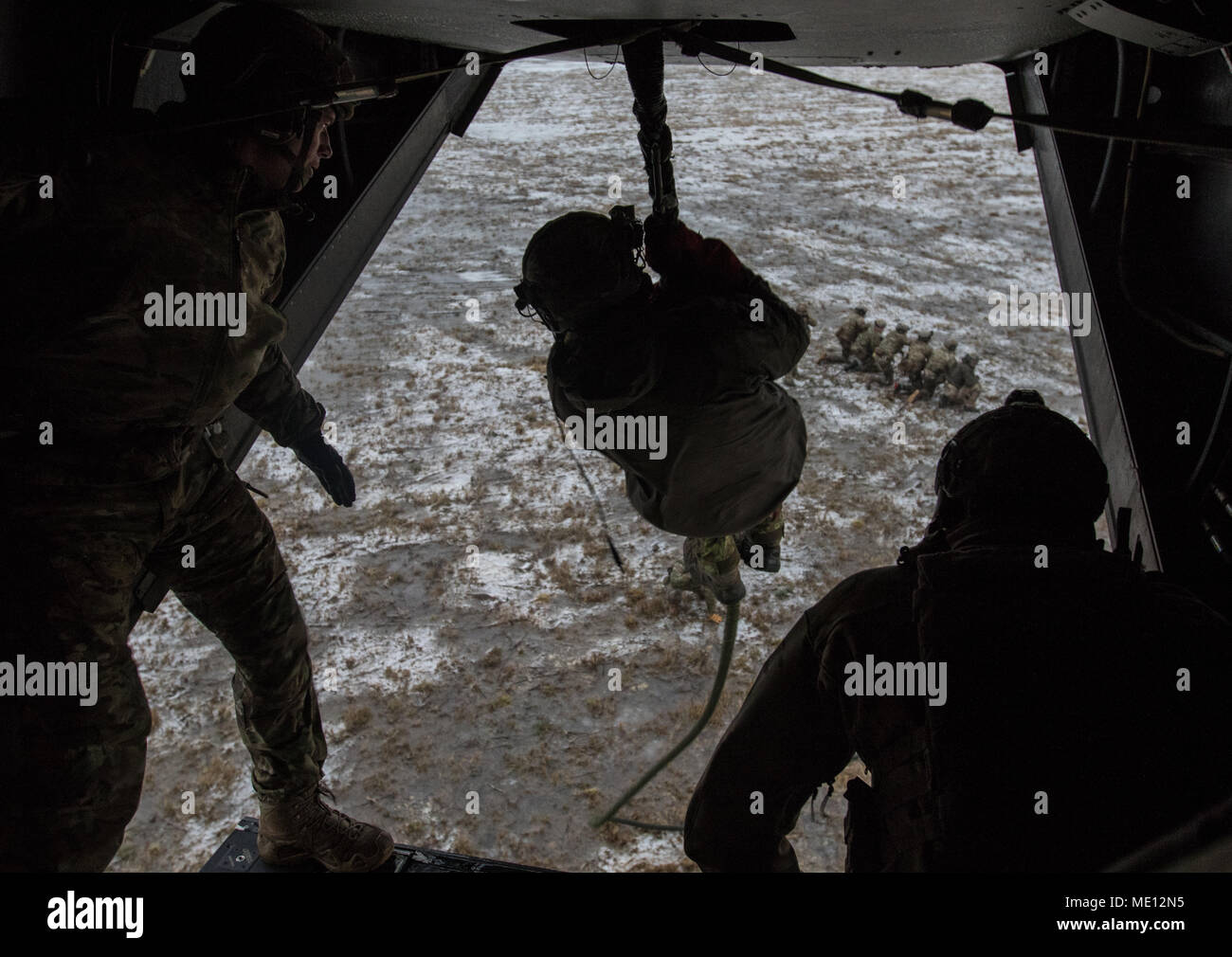 An Estonian Special Operations Forces operator fast ropes out the back ...