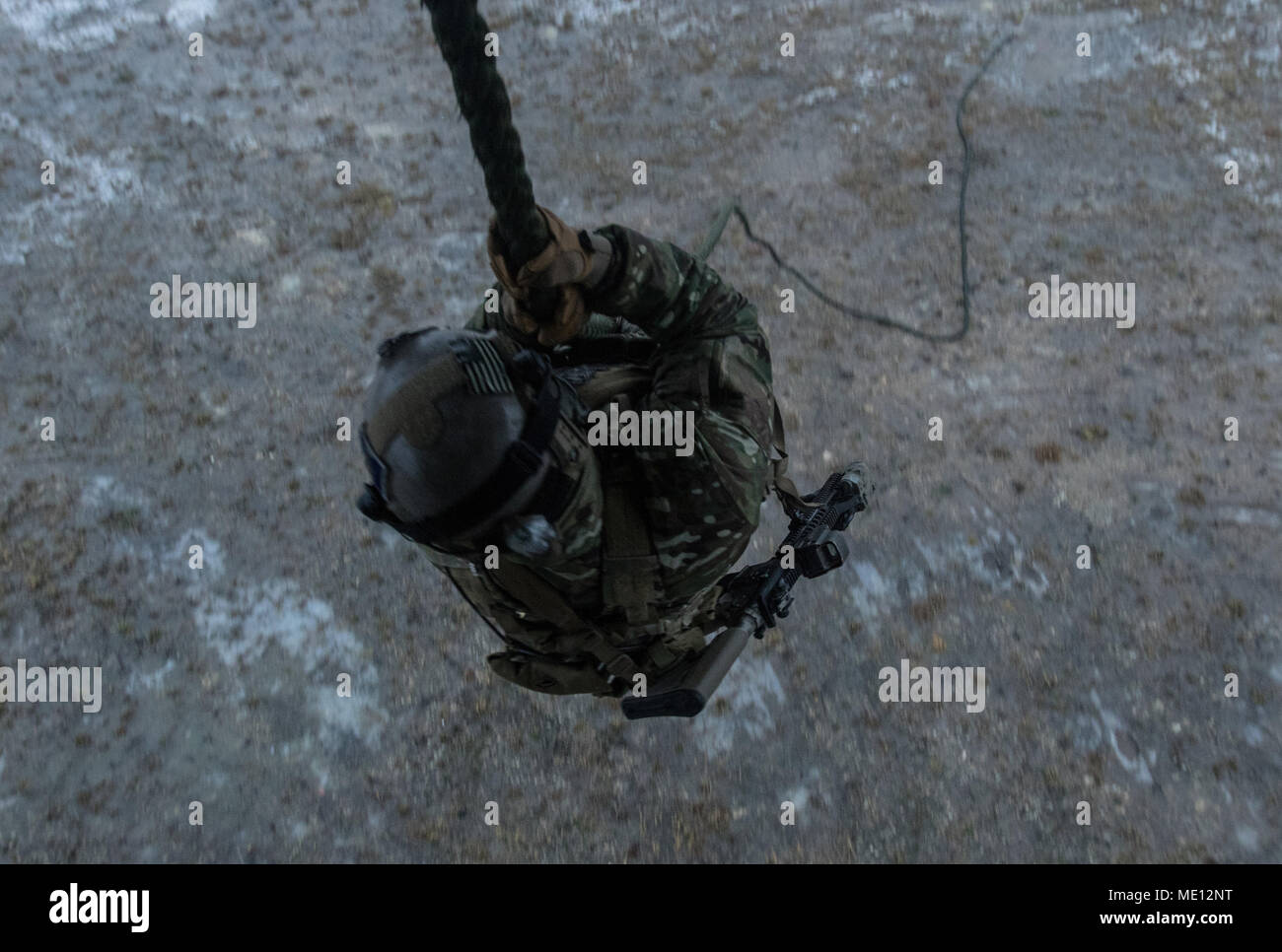 A U.S. Special Operation Forces operator fast ropes out of a CV-22 ...