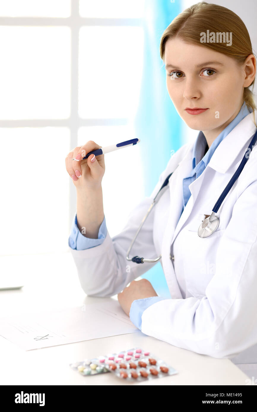 Female doctor filling up medical form on clipboard closeup. Physician ...