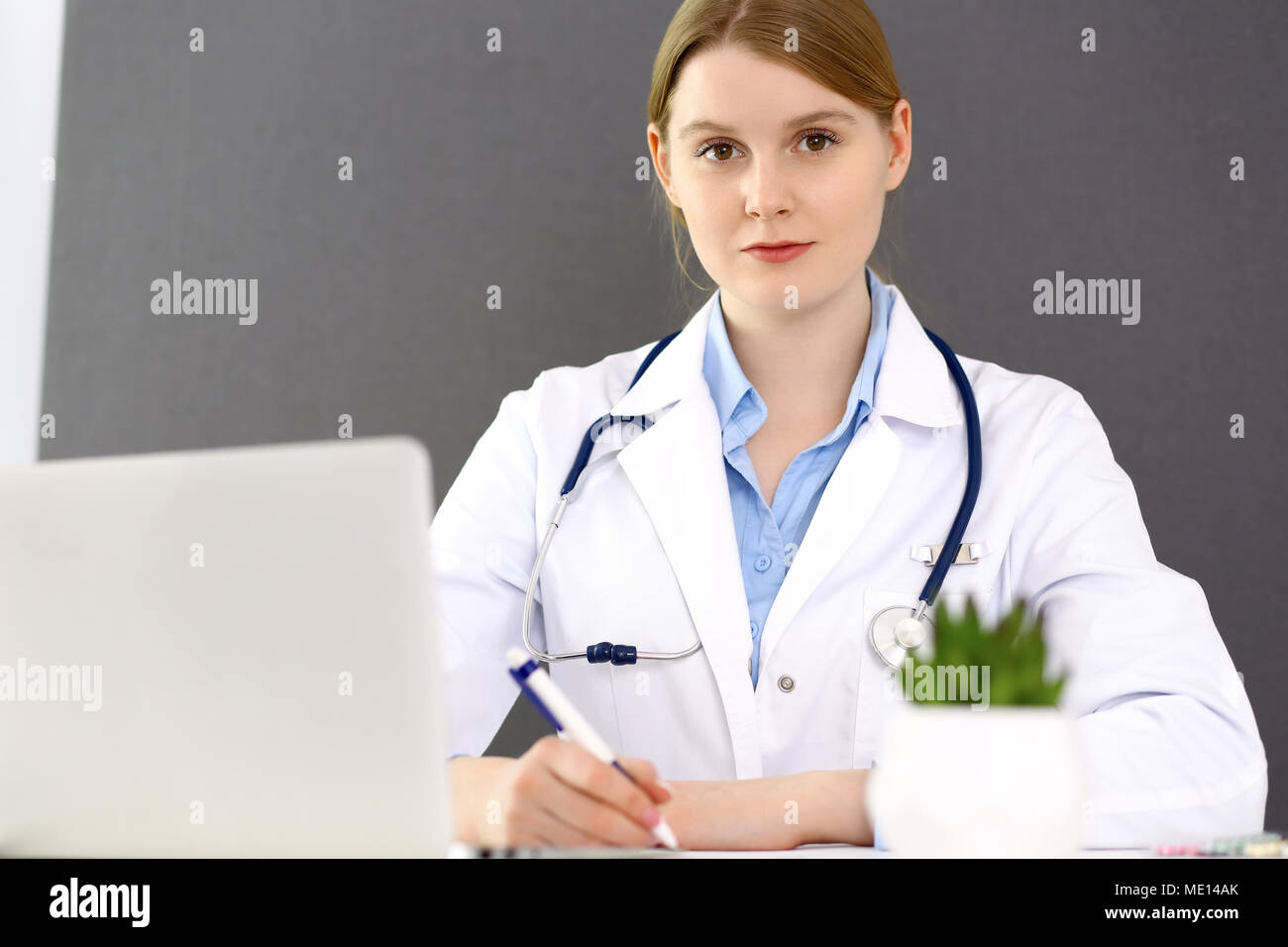 Female doctor filling up medical form on clipboard closeup. Physician ...
