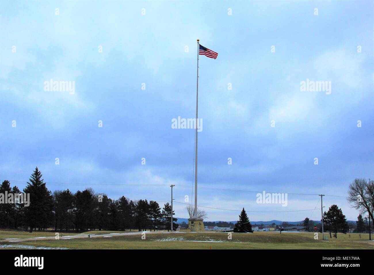 The flag of the United States of America is brightened by a backdrop of ...