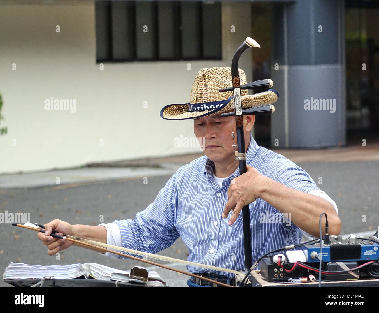 KAOHSIUNG, TAIWAN -- FEBRUARY 16, 2018: A street musician plays the ...