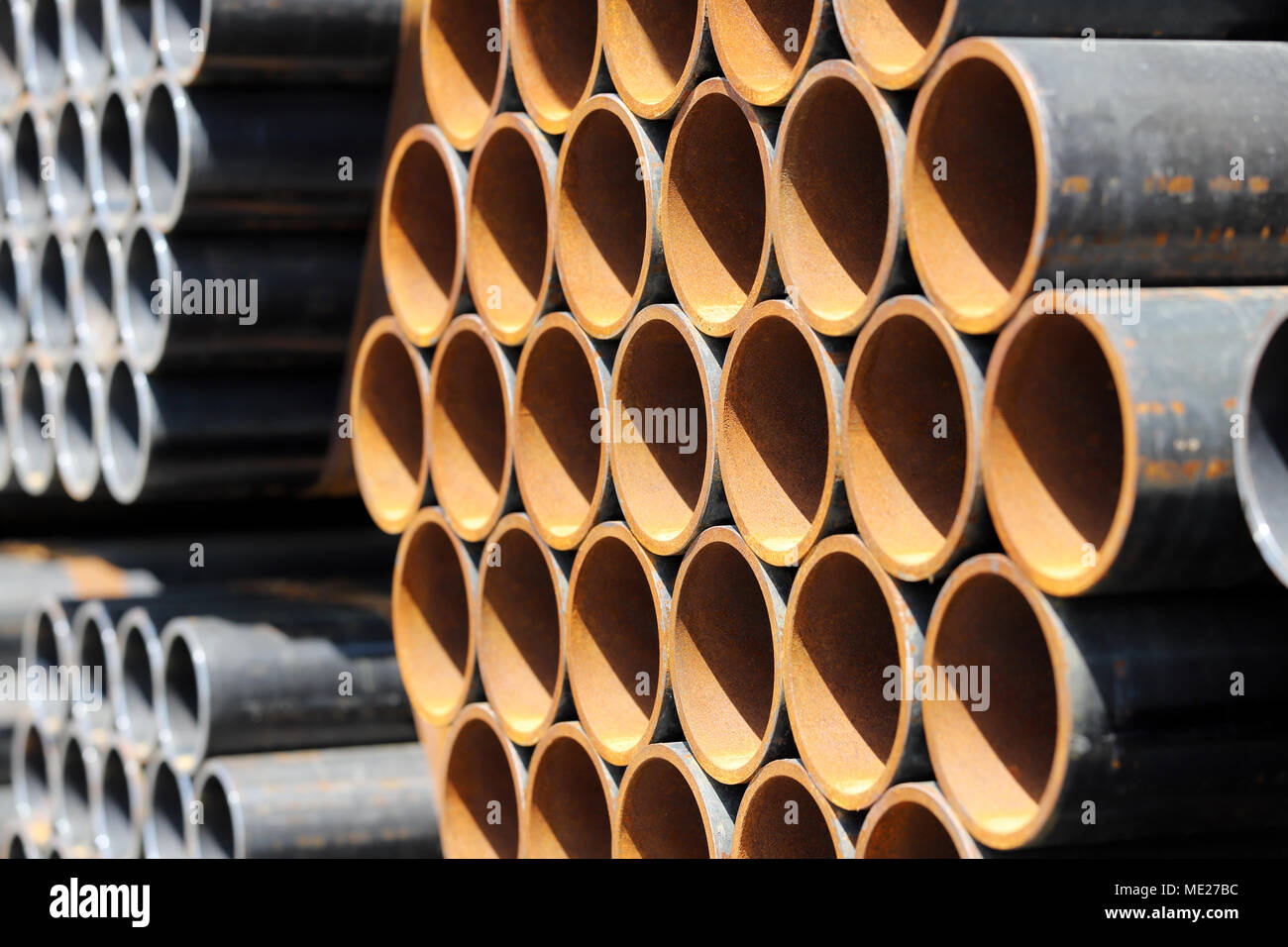 Stack of steel pipes industrial background Stock Photo - Alamy