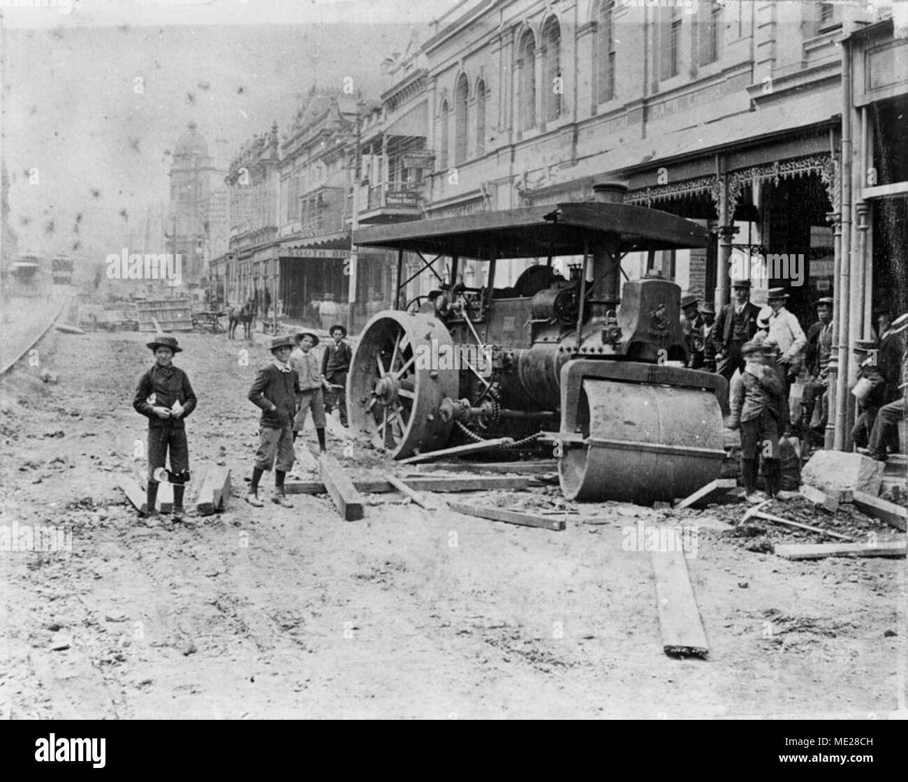 Steam roller bogged in mud while laying wooden paving blocks Stock ...
