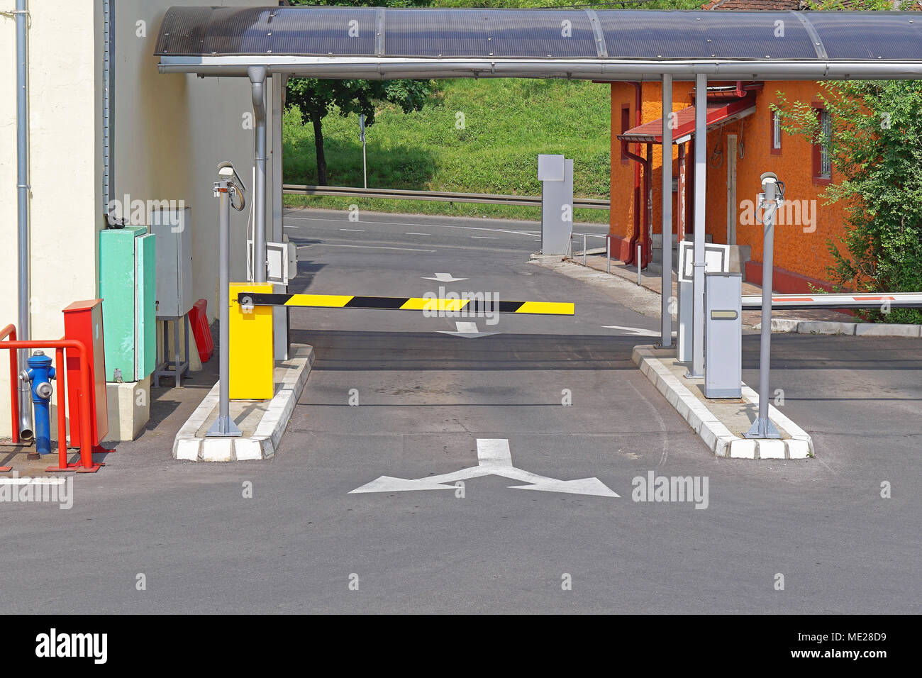 Parking lot entrance with barrier ramp Stock Photo - Alamy