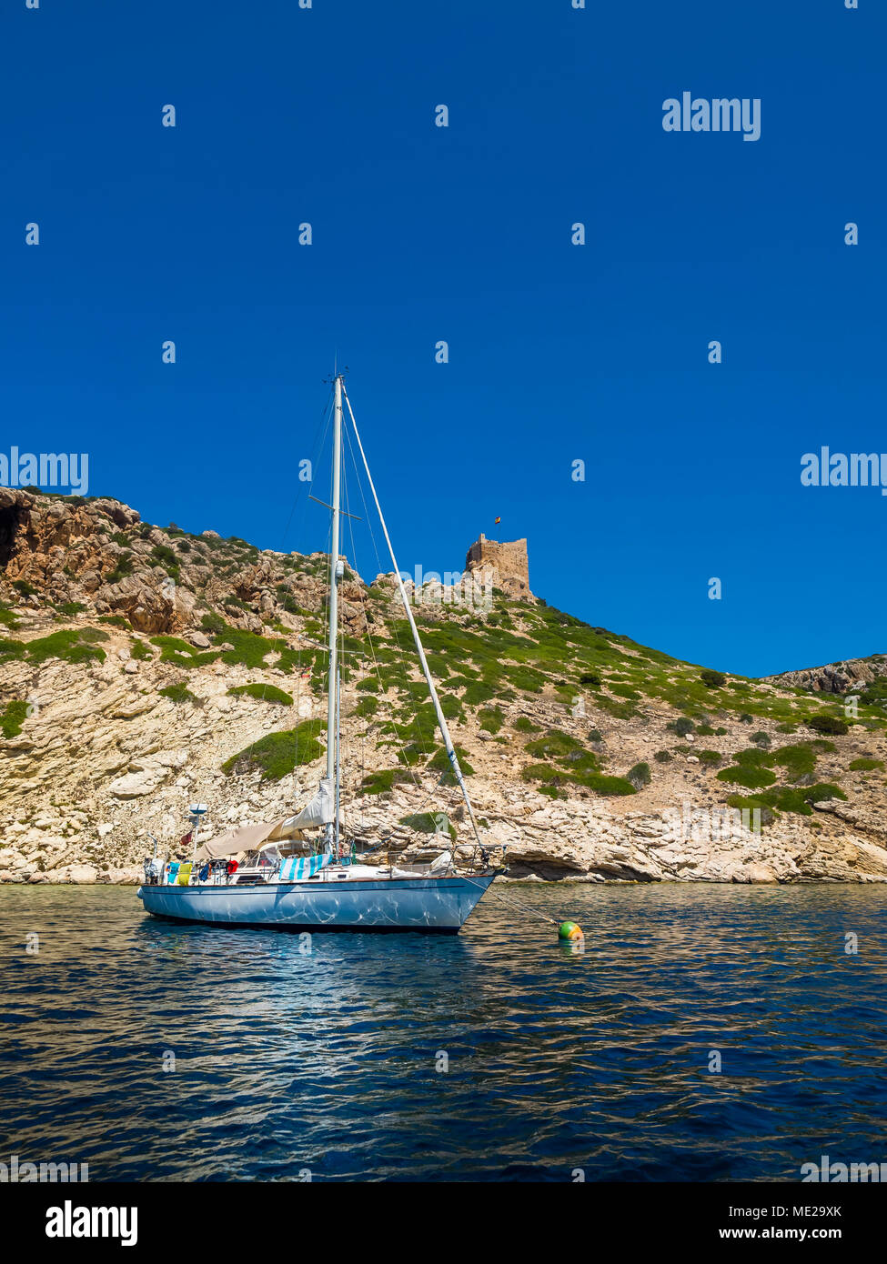 Sailboat in the harbour behind it Cabrera Castle, Colònia de Sant Jordi ...