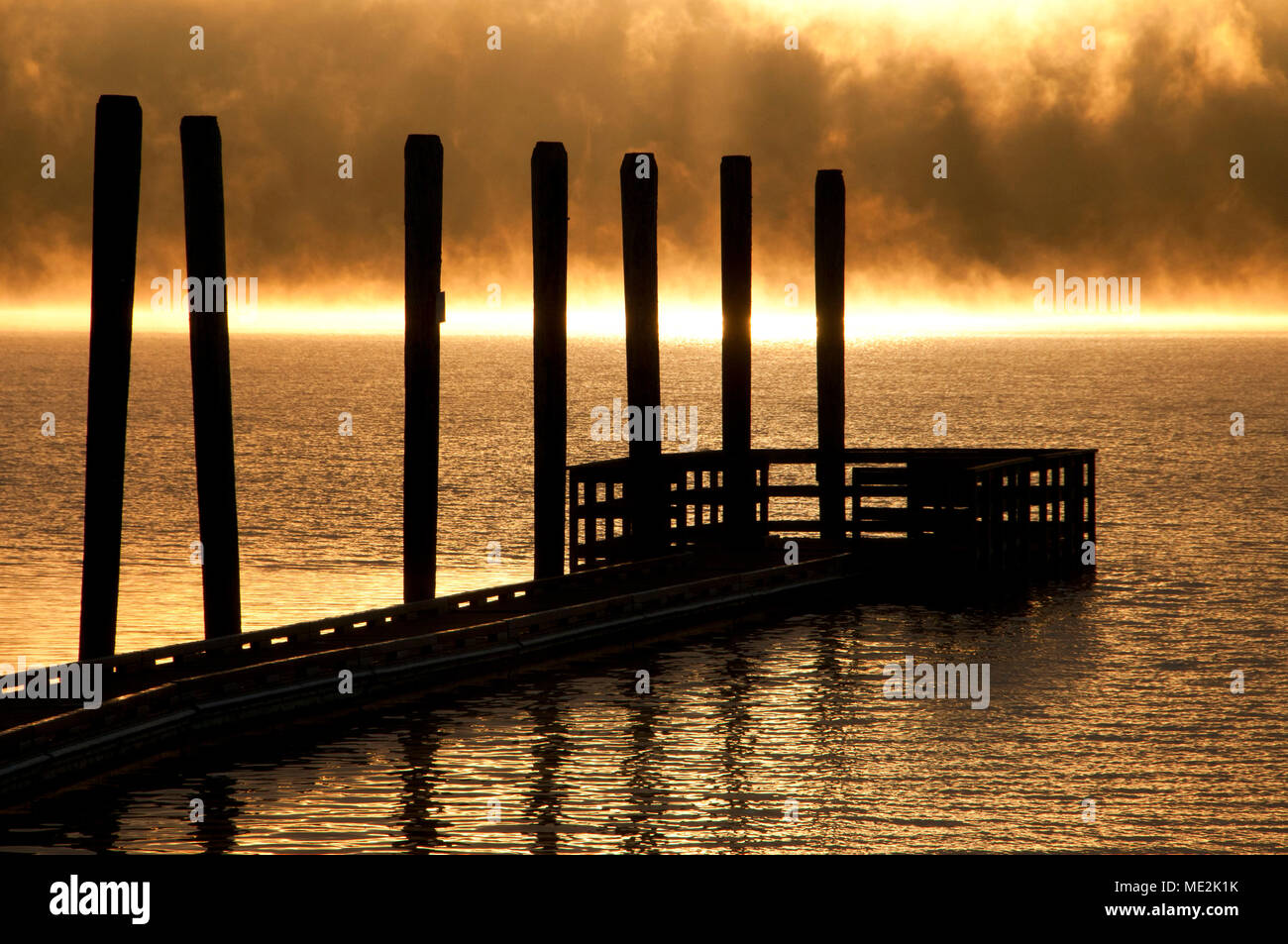 Dock sunrise on Siltcoos Lake, Westlake County Park, Oregon Stock Photo ...