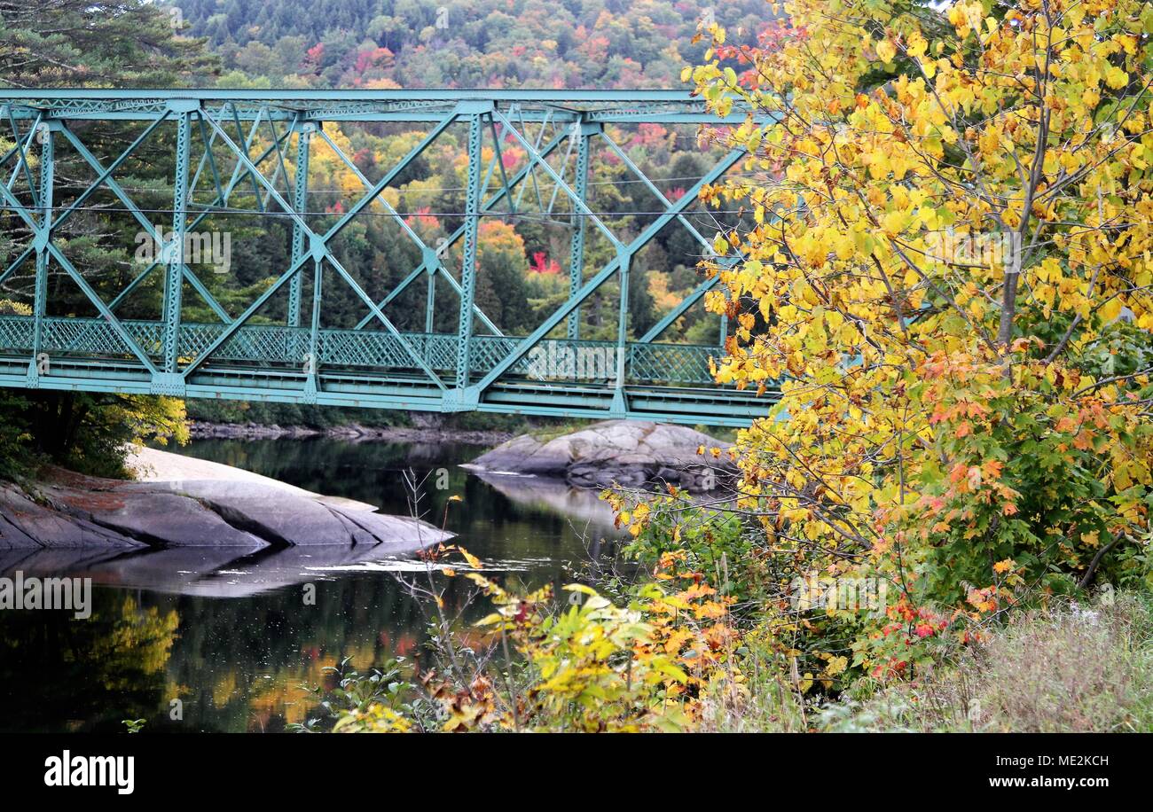 Scenic fall views of of peaceful river, bridge and colorful autumn ...
