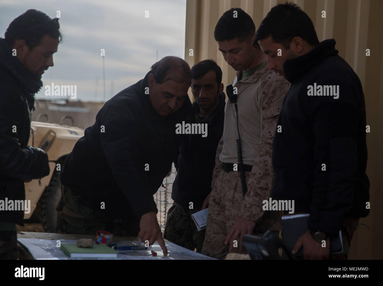 A U.S. Marine advisor with Task Force Southwest battle tracks with ...