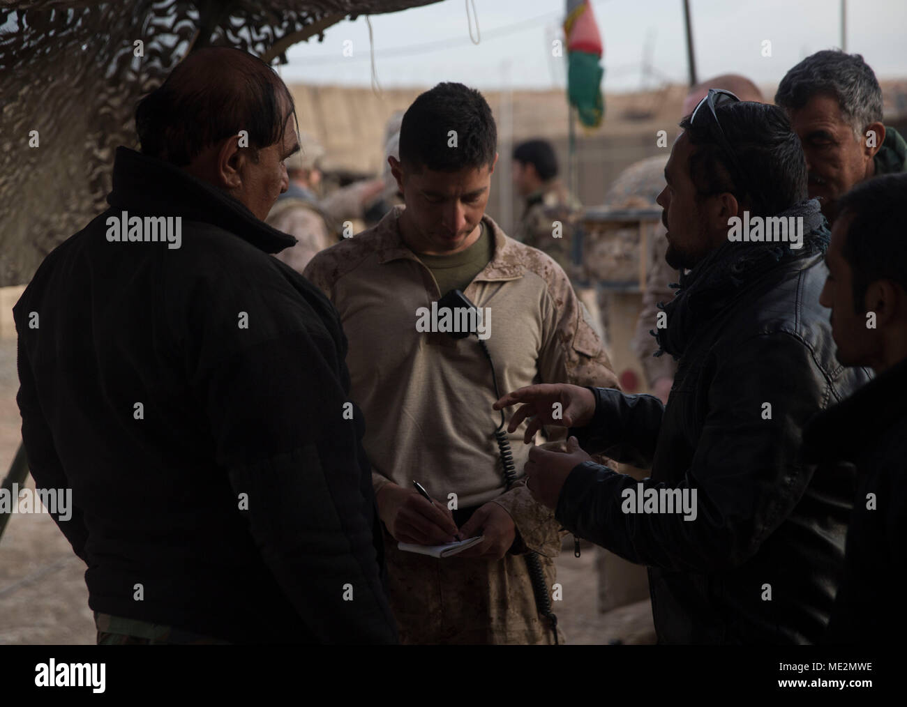 A U.S. Marine advisor with Task Force Southwest assists his counterpart ...