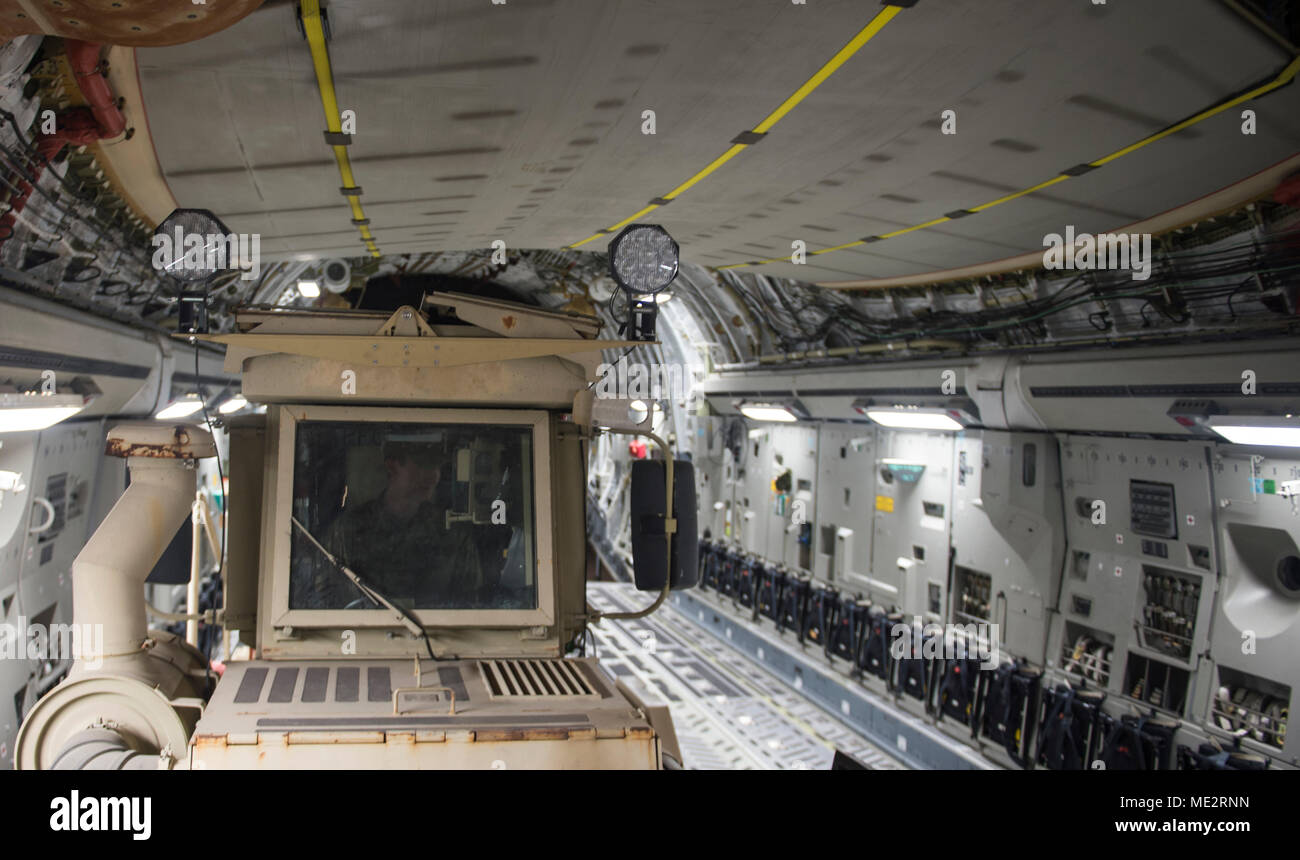 A U.S. Air Force air transportation specialist drives a Husky vehicle ...