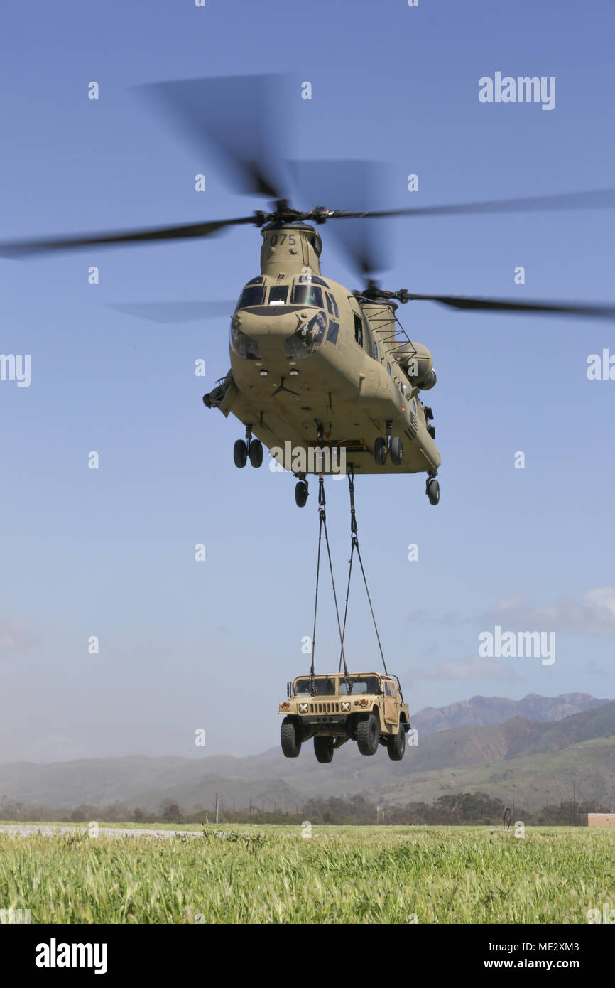 U.S Army pilots lift the Humvee off of the ground during sling load ...