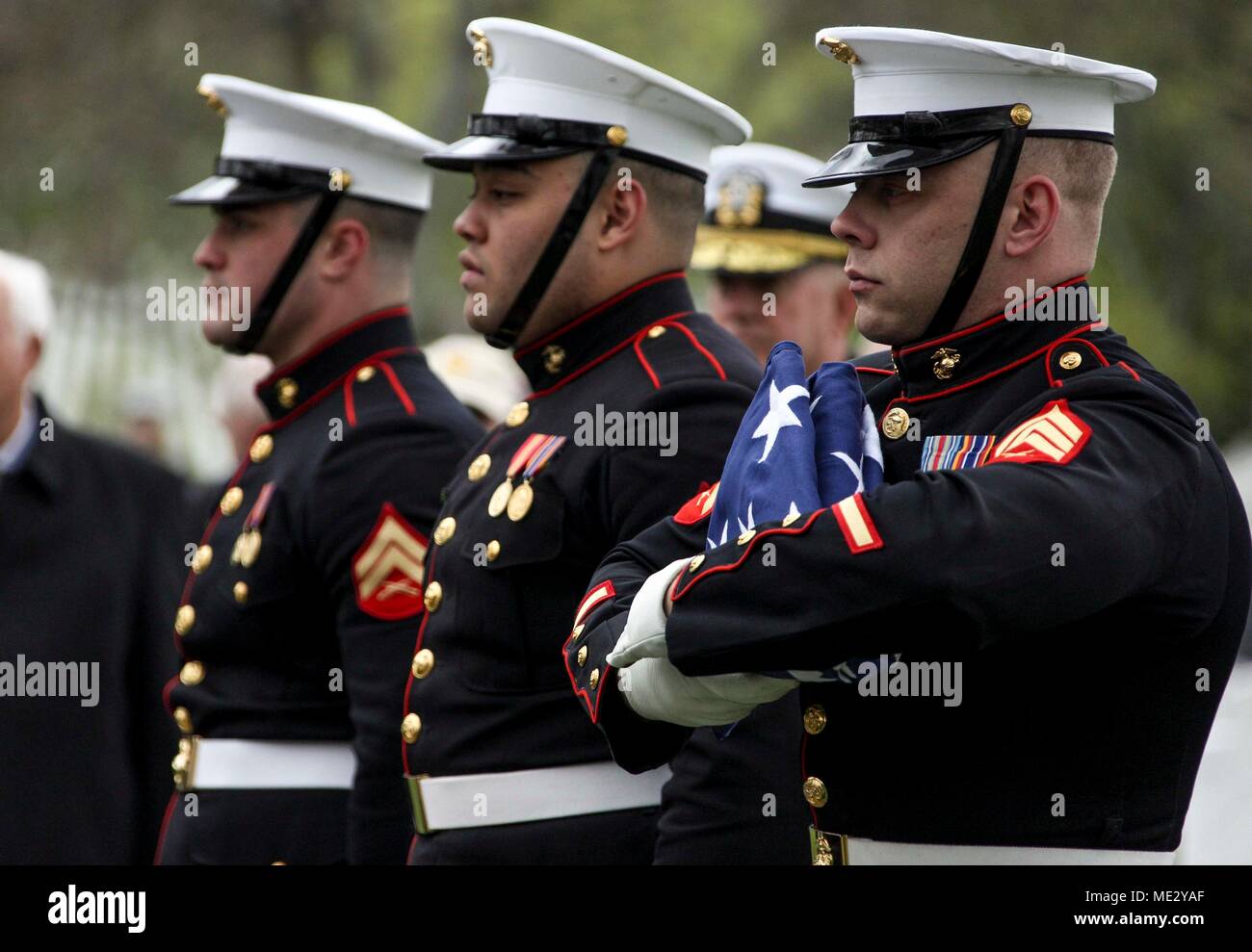 U.S. Marine with Marine Barracks Washington holds an American flag ...