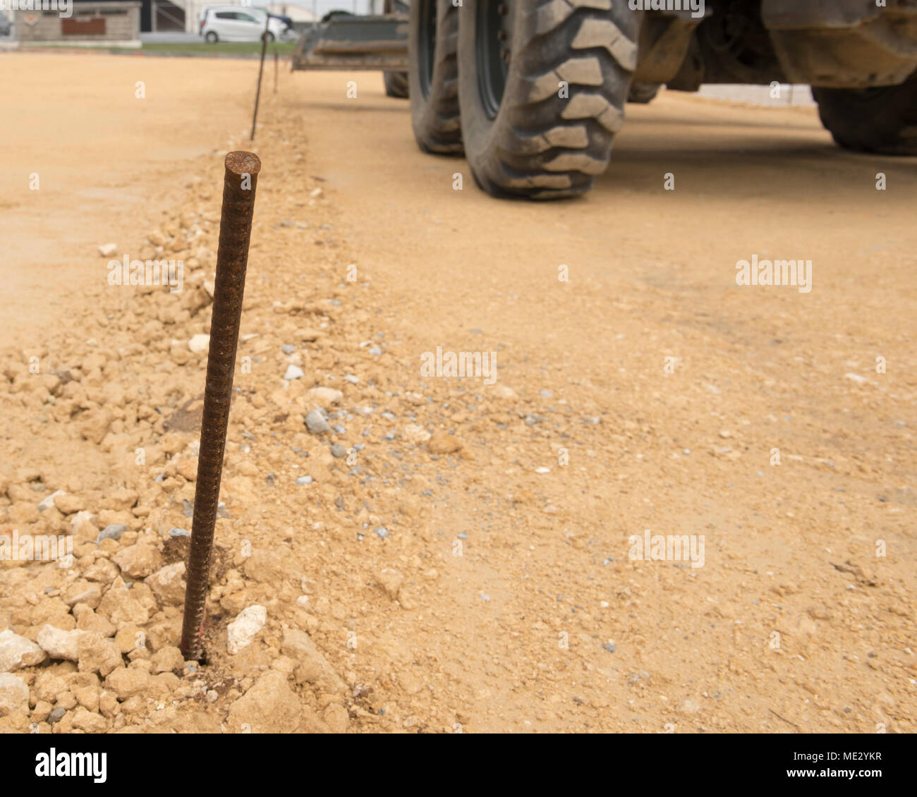 In-ground stakes signify paving lanes during a parking lot expansion ...