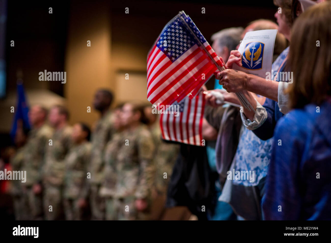 Soldiers fill their seats as family and friends cheer during the ...