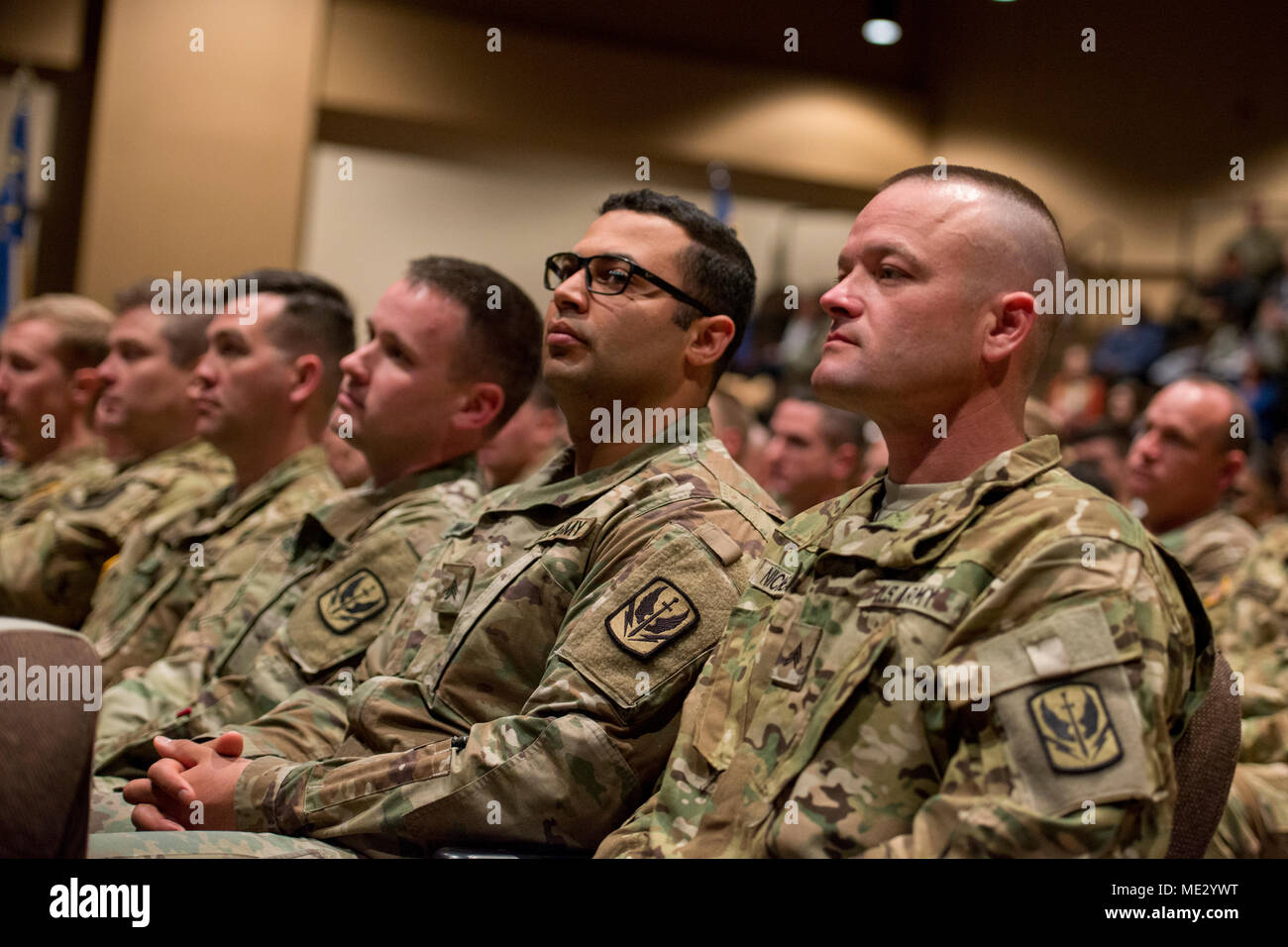 Soldiers fill their seats as family and friends cheer during the ...