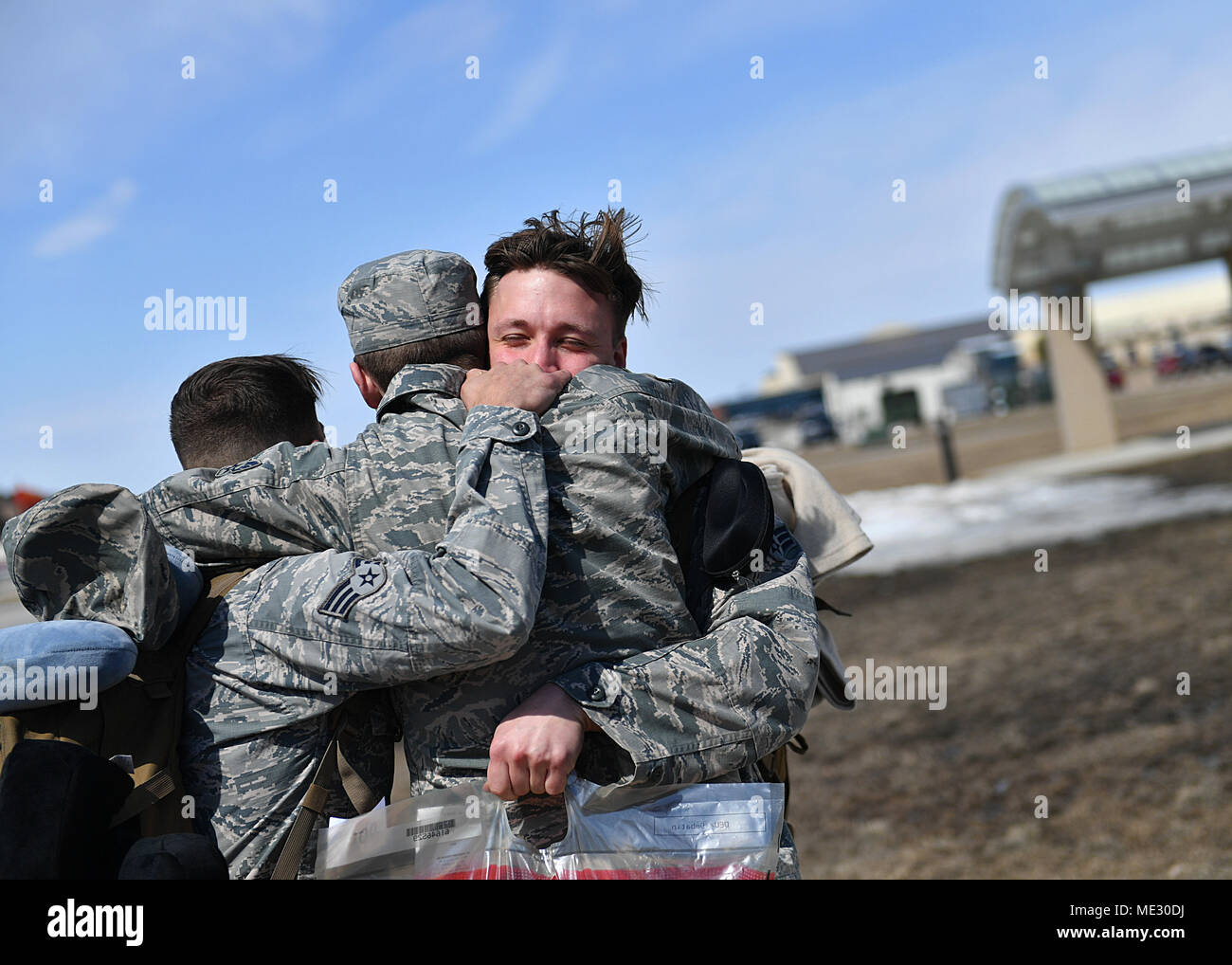 Team Minot Airmen embrace each other during a welcome home reunion to ...