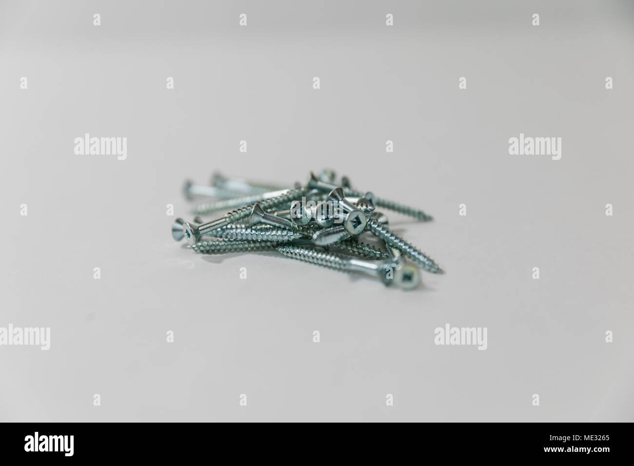 Screws on white background Stock Photo - Alamy
