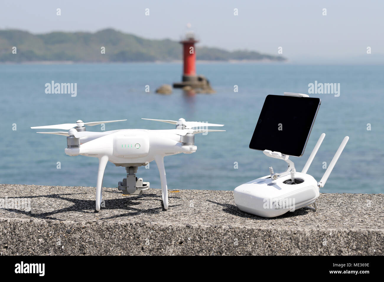 drone and remote controller with monitor on concrete jetty Stock Photo ...