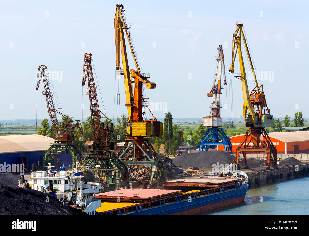 Cargo crane, freight traine and coal in port Stock Photo - Alamy