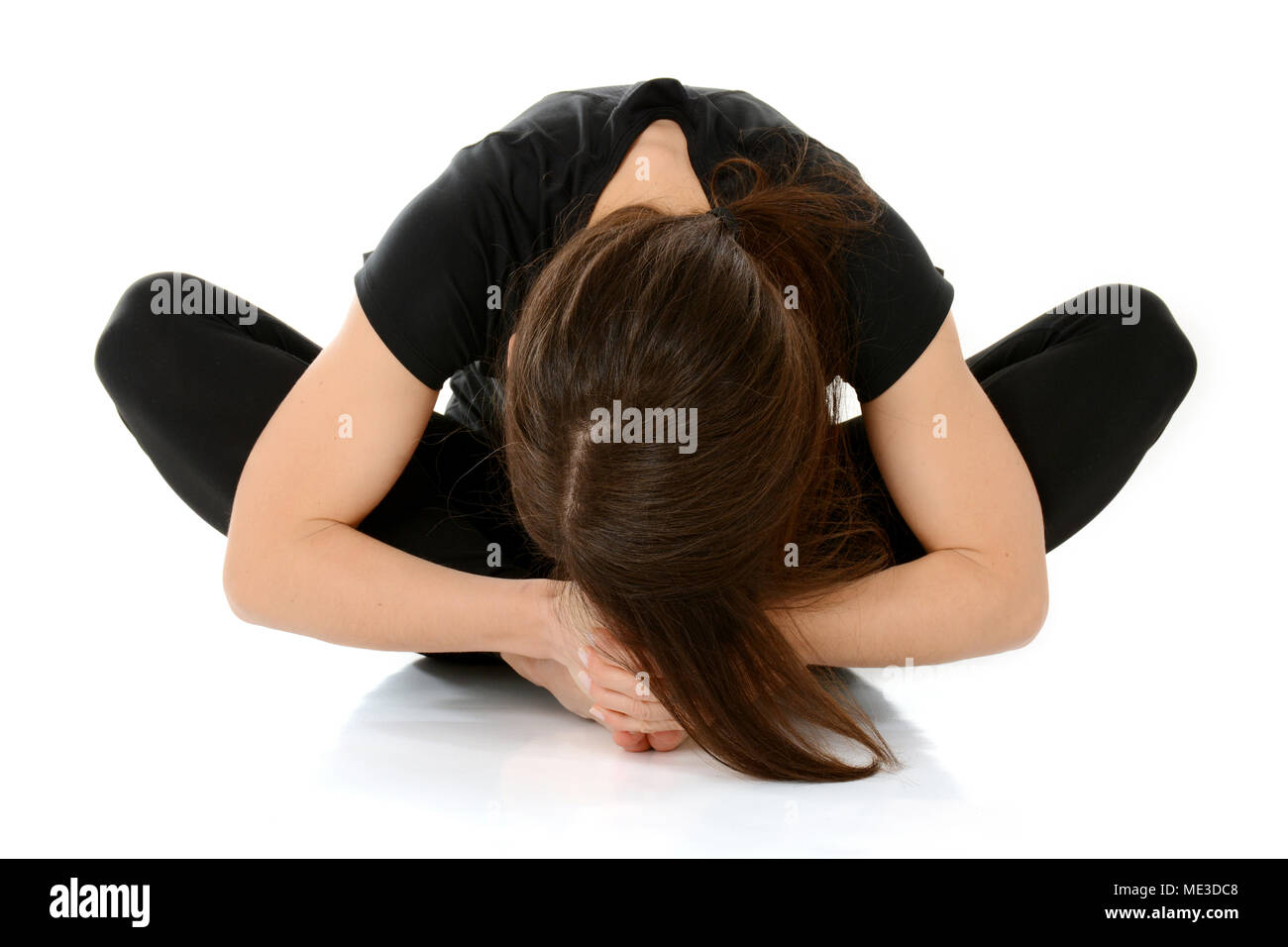 Young woman doing yoga asana Bound Angle Pose Baddha Konasana isolated ...