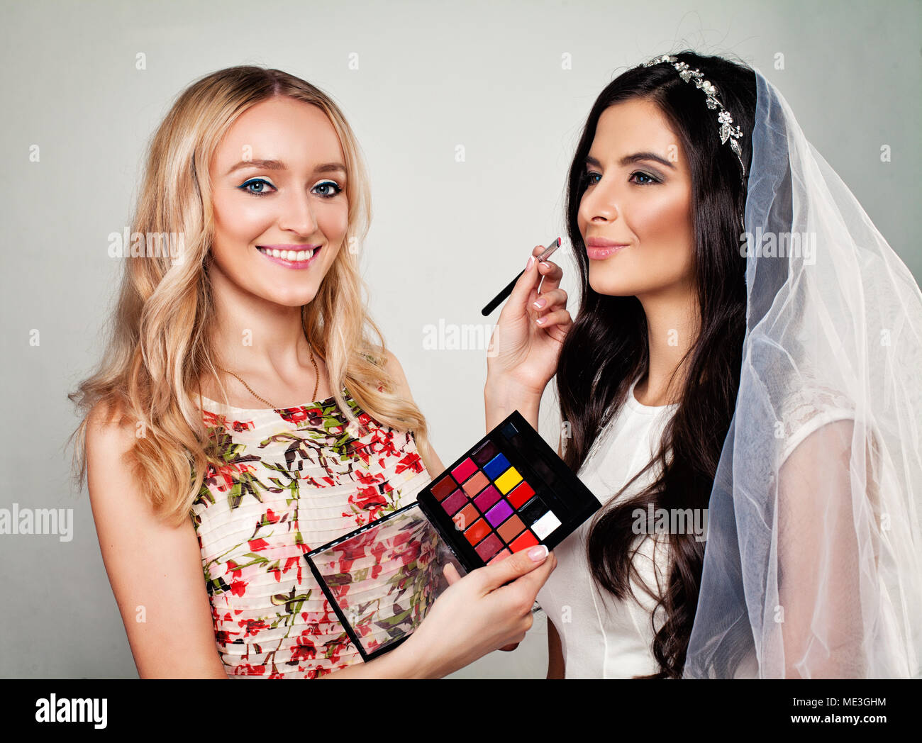 Perfect Fashion Model and Beautiful Woman Makeup Artist holding Makeup ...