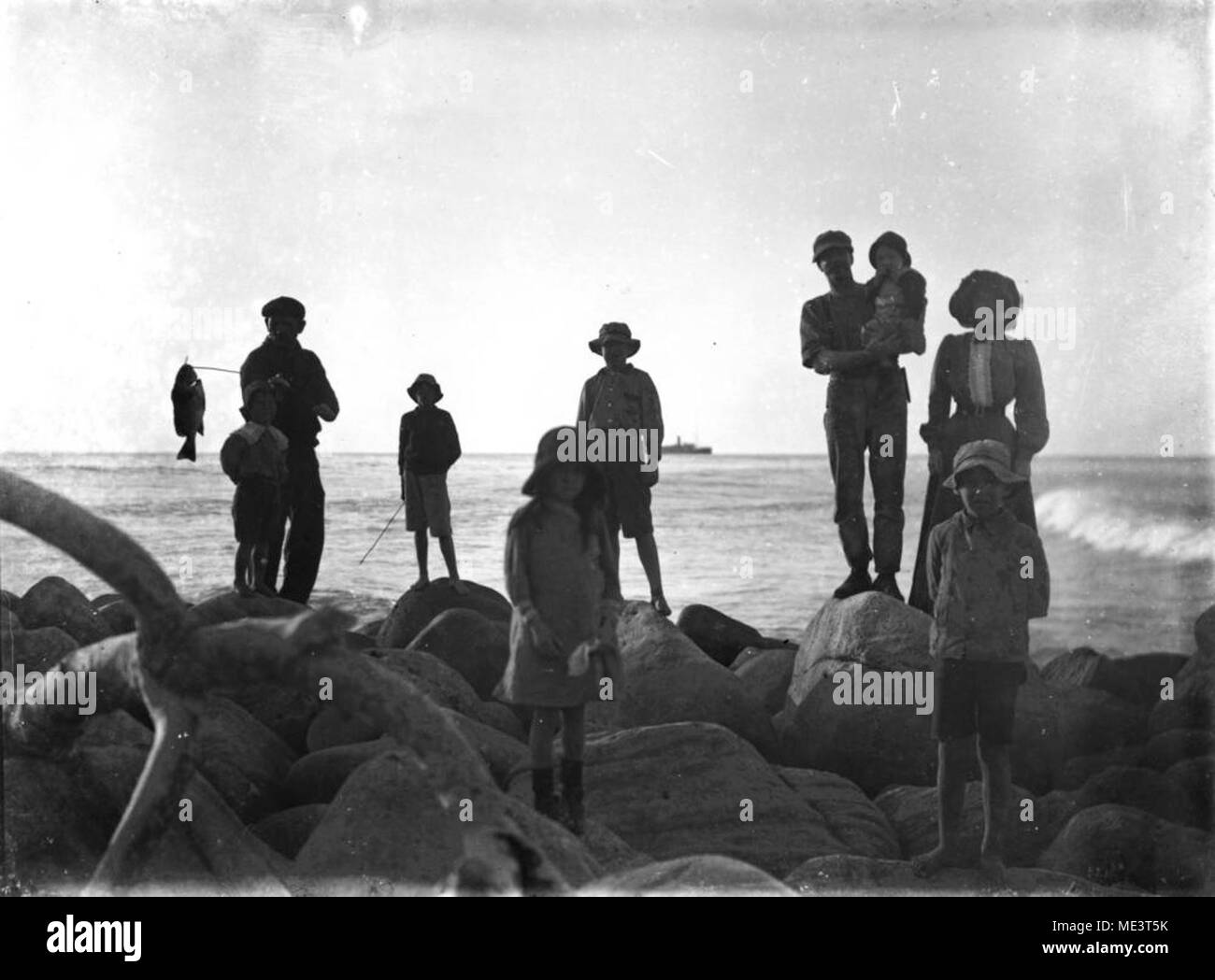 Byrne family photographed in silhouette against the ocean at Cape Stock ...