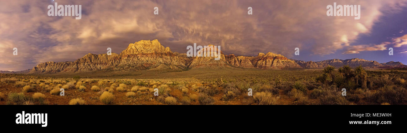 panorama of Red Rock Conservation Area at night lit by the glow from ...
