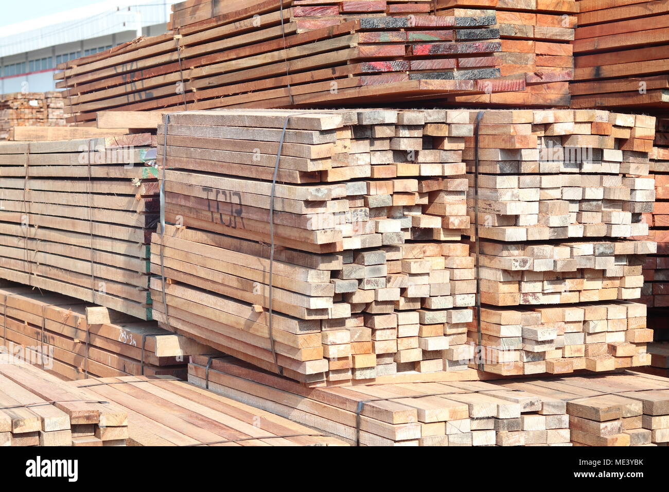 Stack of square rubberwood for furniture industry Stock Photo - Alamy