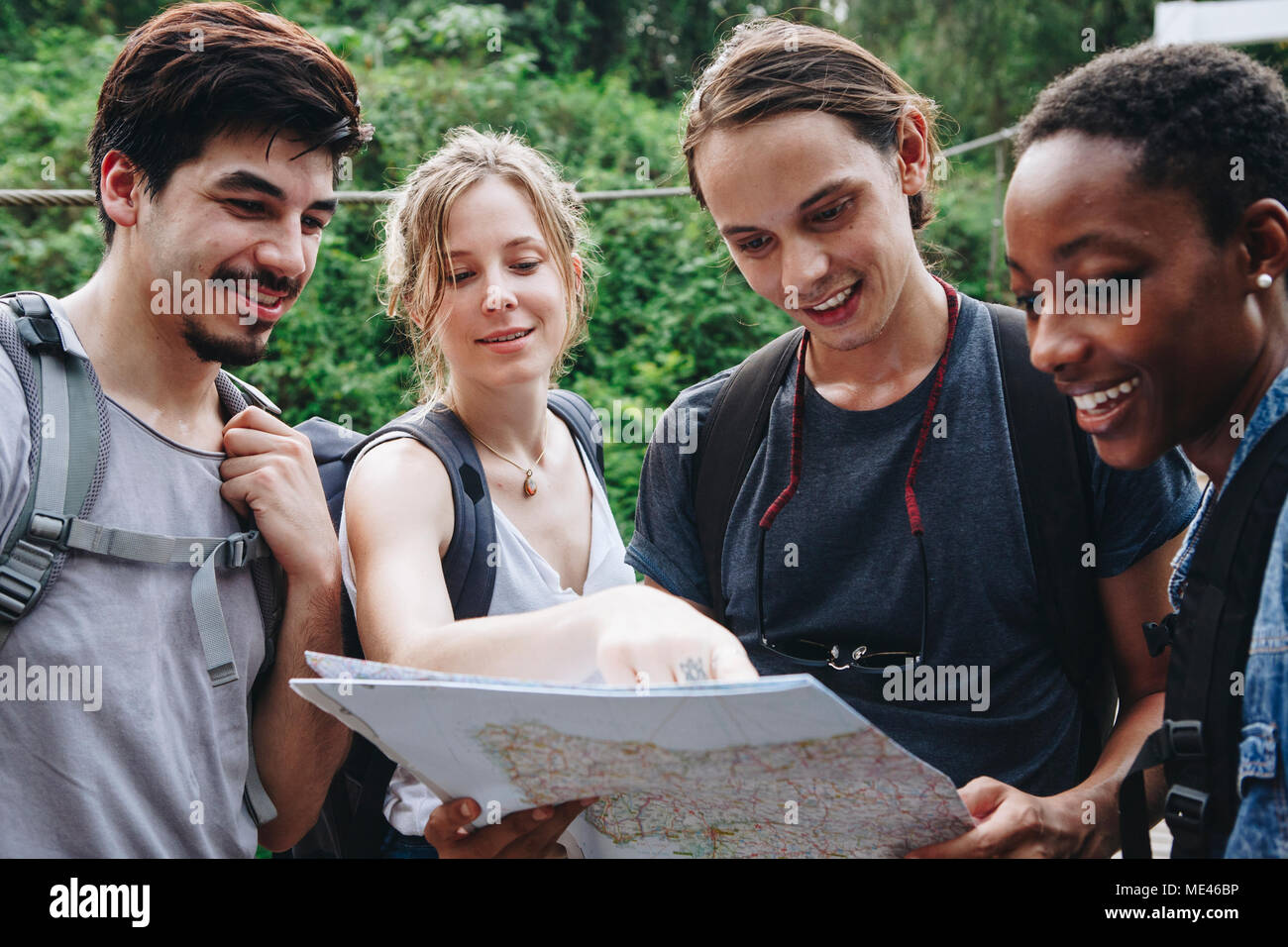 Friends finding their way in nature with a map Stock Photo - Alamy