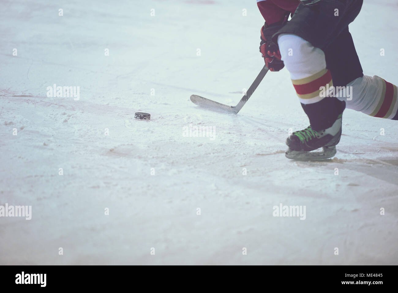 ice hockey player in action kicking with stick Stock Photo - Alamy