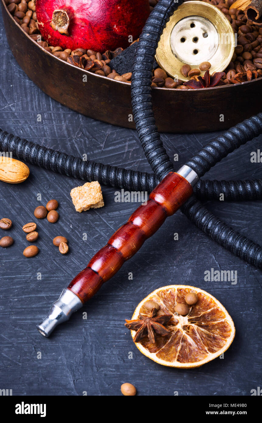 Smoke hookah with with coffee beans and pomegranate.Shisha concept ...