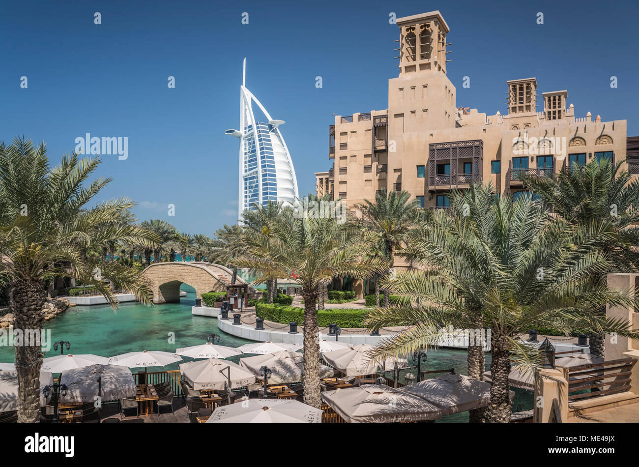 The Madinat Jumeirah canal and waterway with the white Burj Al Arab in ...