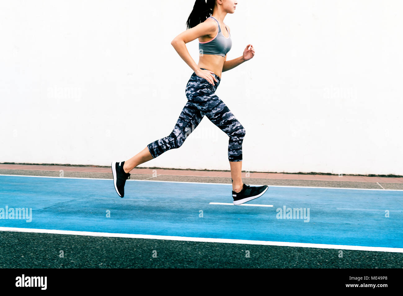 White woman running on track Stock Photo - Alamy