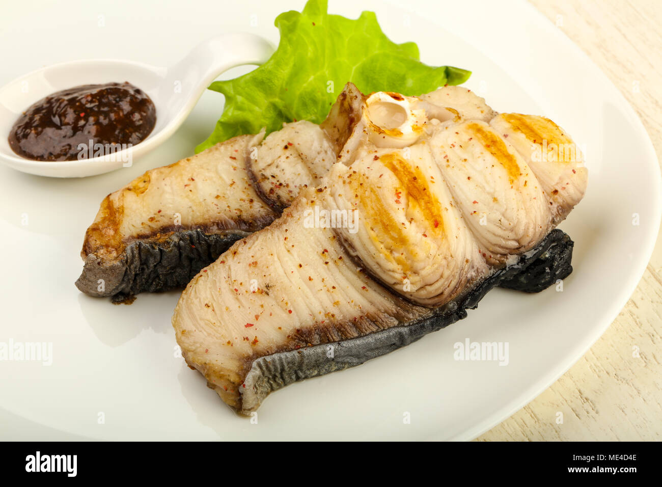Grilled shark steak with pepper sauce and salad leaves Stock Photo - Alamy